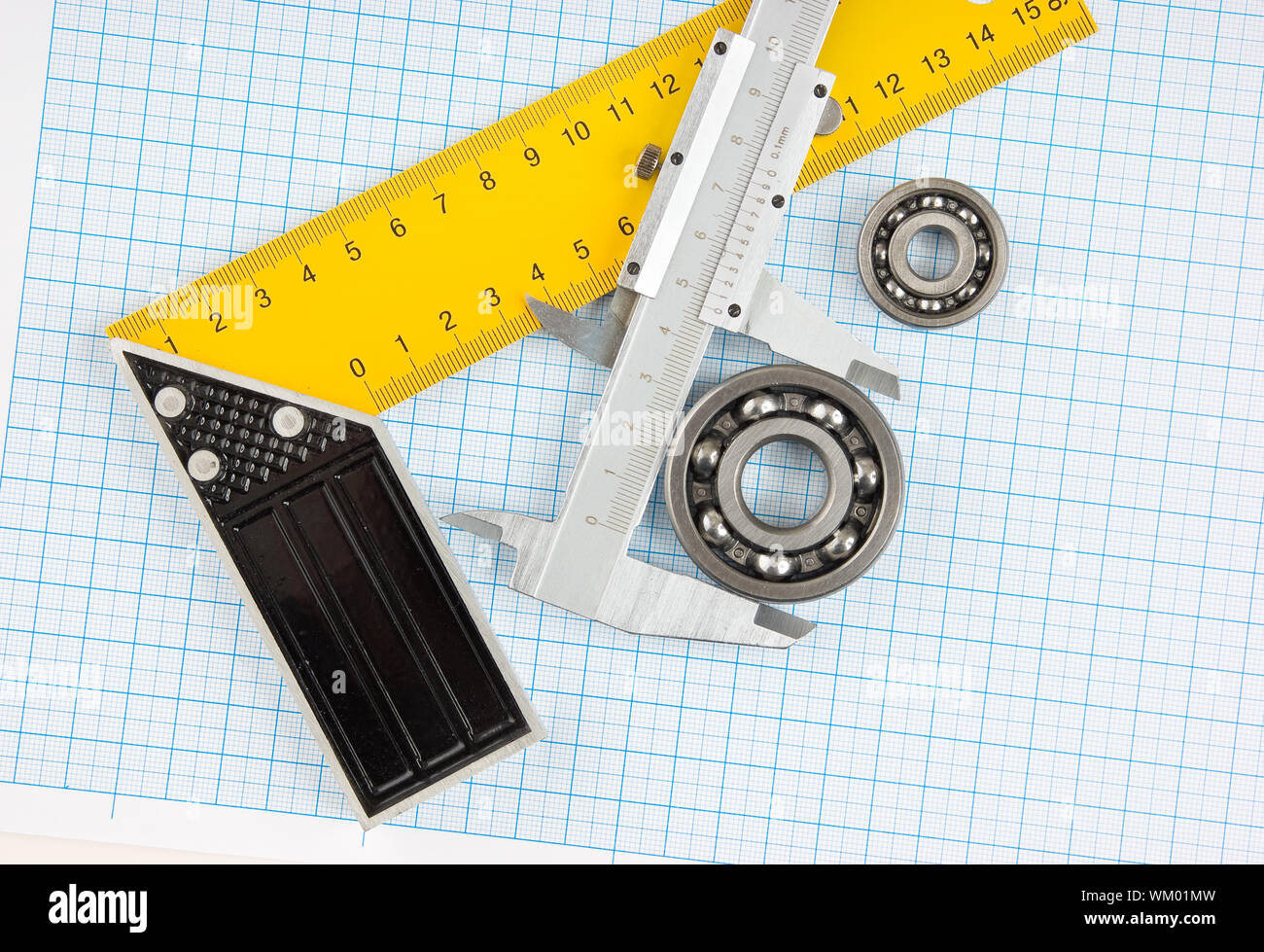calipers, bearing and square on the background of graph paper Stock ...