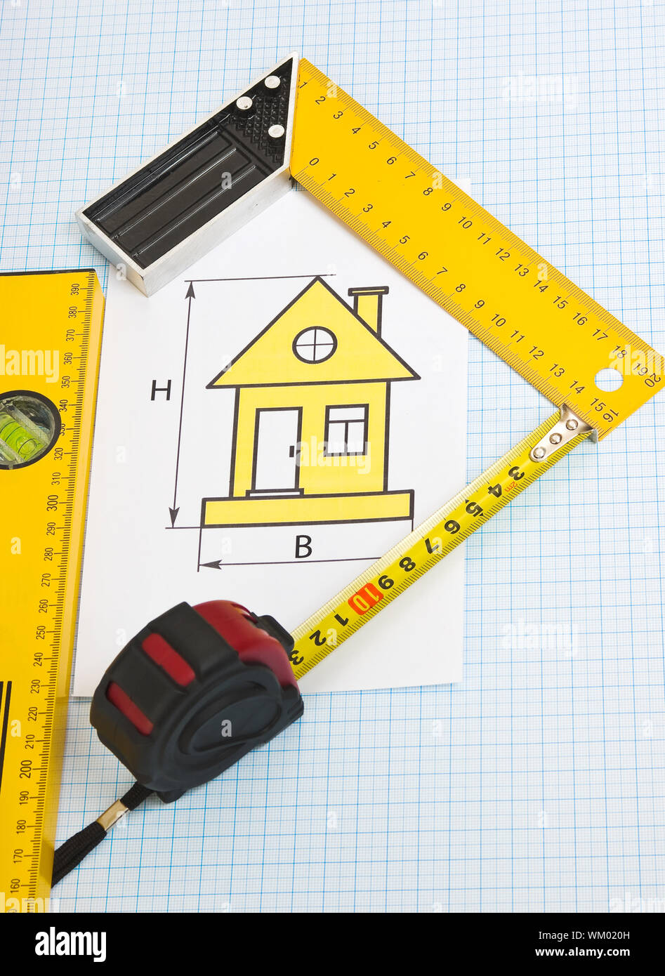 drawing at home with construction tools on a background of graph paper ...