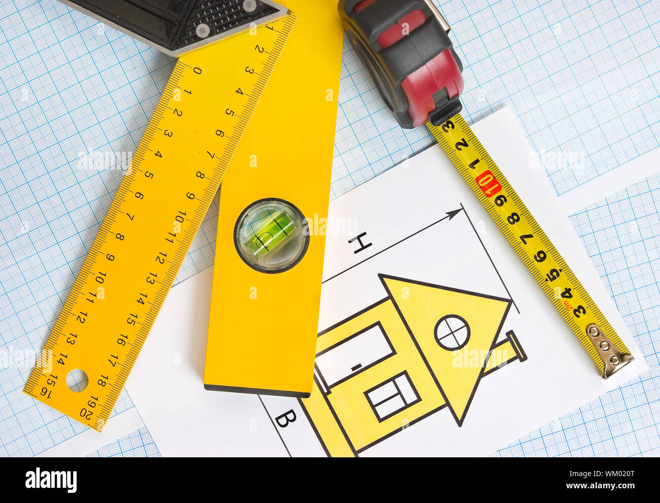 drawing at home with construction tools on a background of graph paper ...