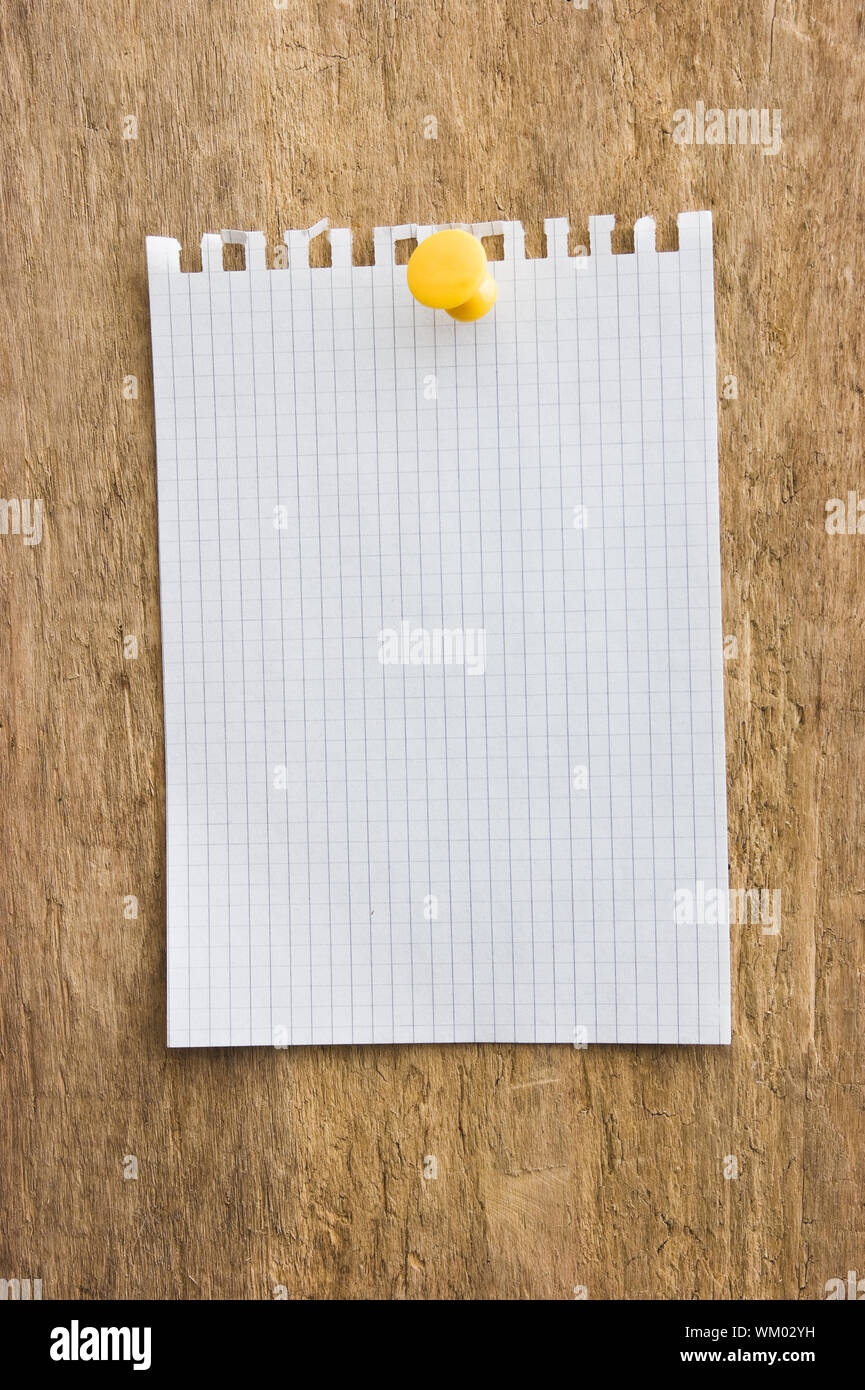 A piece of paper pinned the button on the board Stock Photo - Alamy