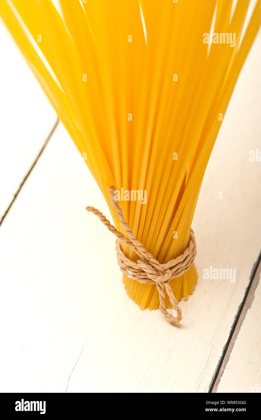 Italian pasta spaghetti tied with a rope on a rustic table Stock Photo ...