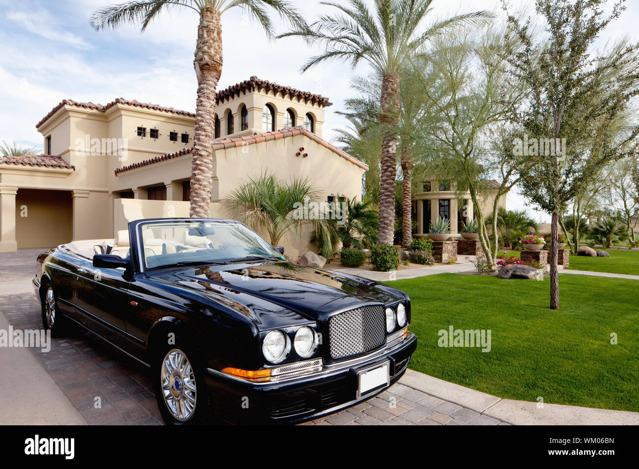 Black open roof car parked outside mansion house Stock Photo - Alamy