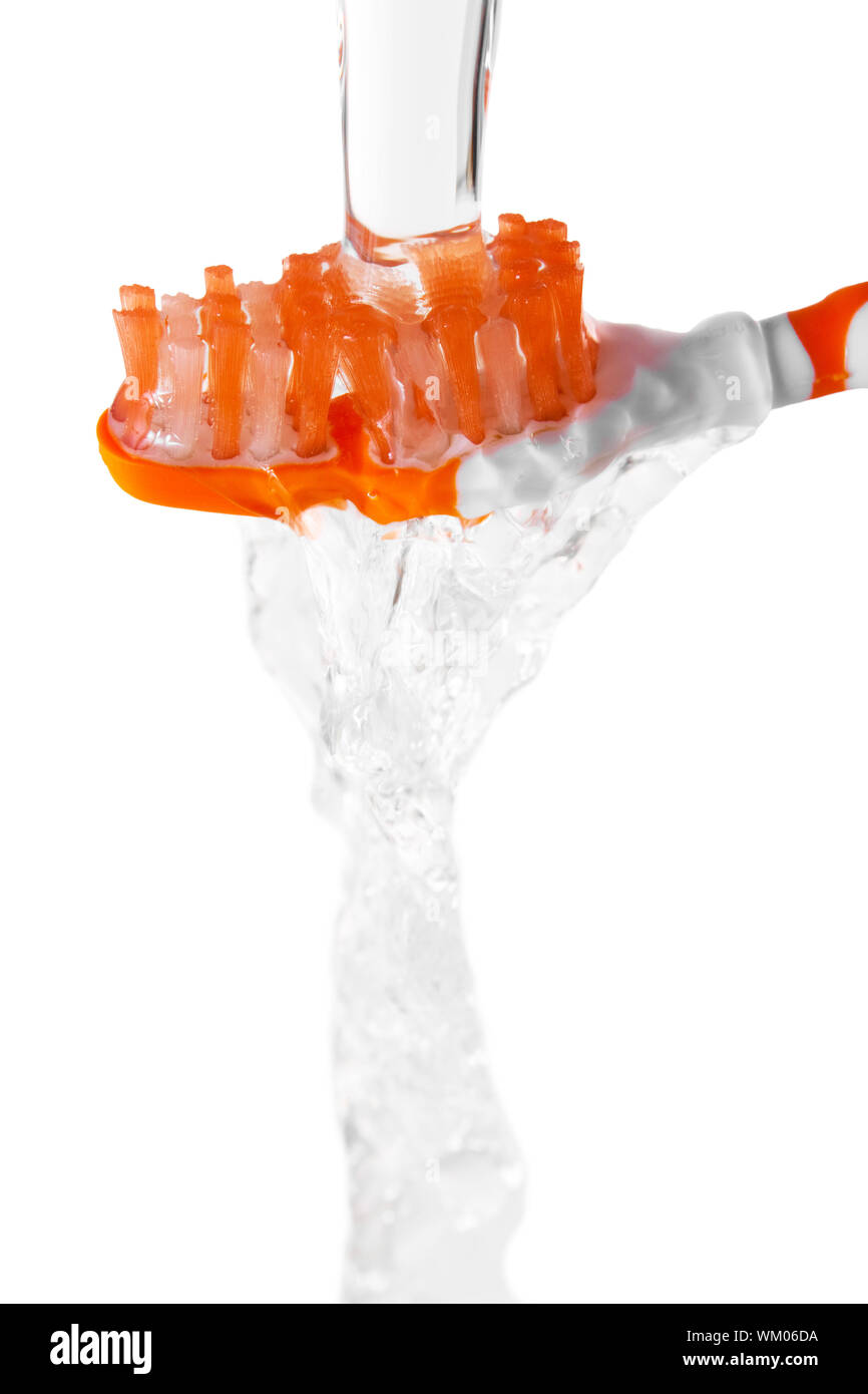 water flows to the toothbrush Isolated on white background Stock Photo ...