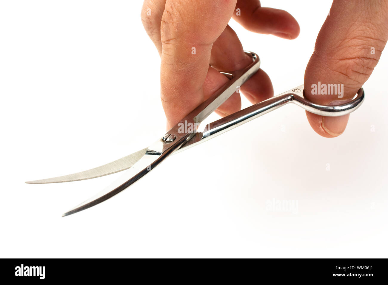 Chrome scissors in hand isolated on white background Stock Photo - Alamy