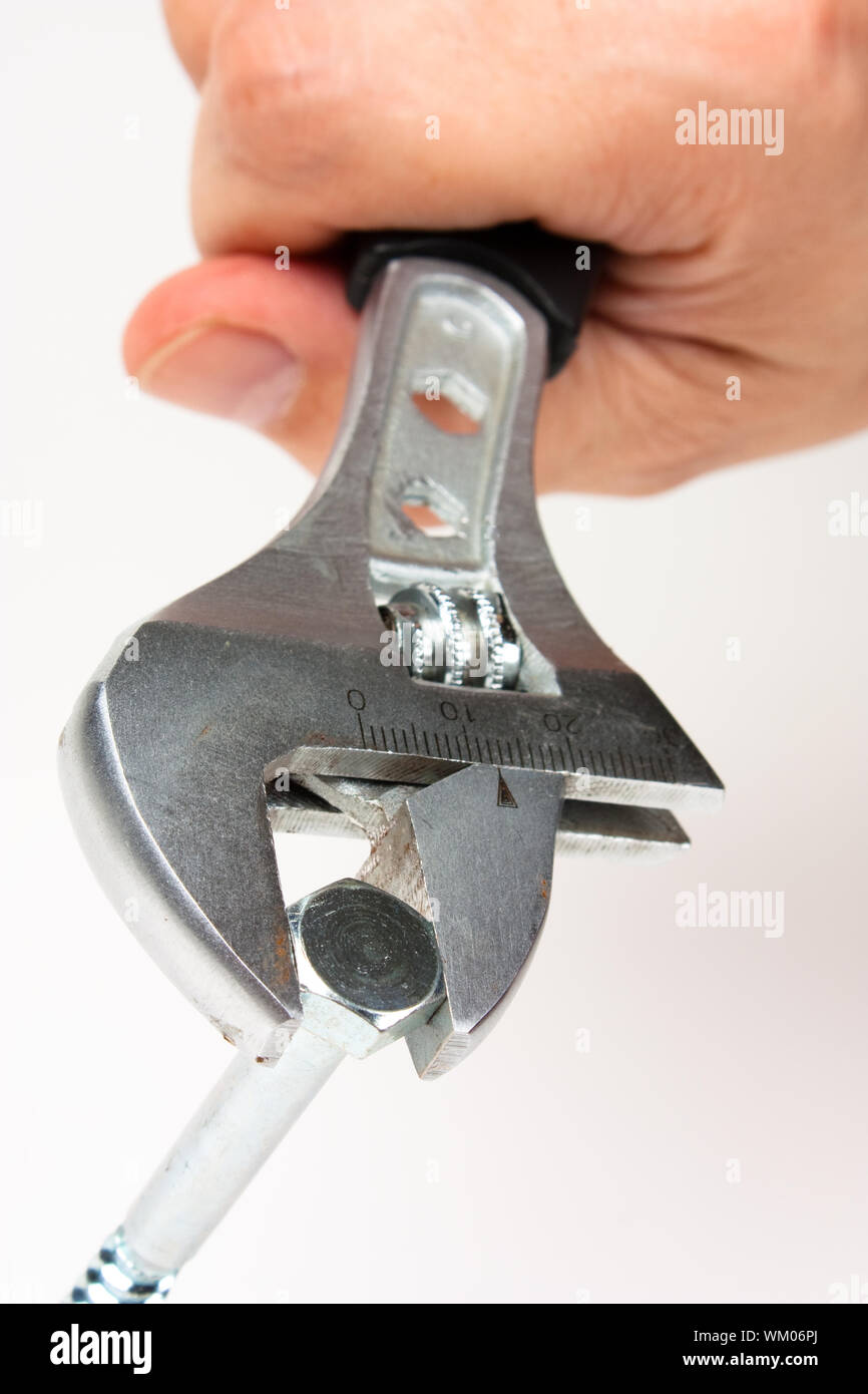 wrench with the screw in his hand isolated on white background Stock ...