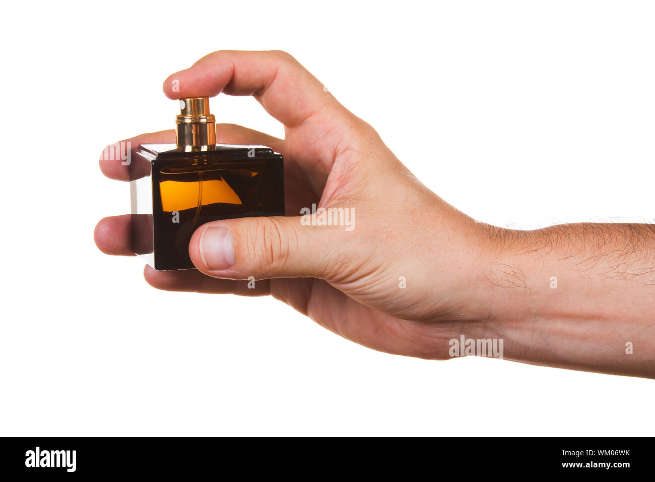 bottle of cologne in his hand isolated on a white background Stock ...