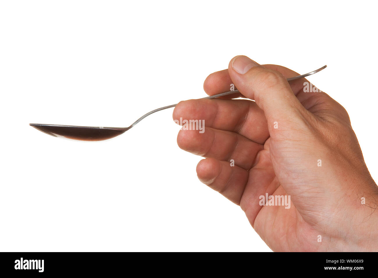 spoon in hand isolated on white background Stock Photo - Alamy