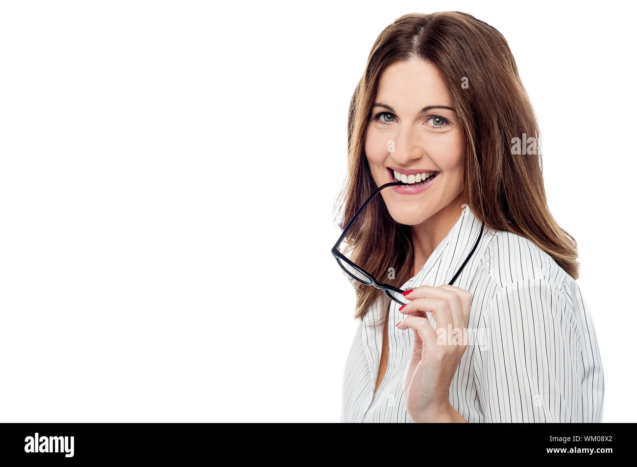 Mischievous smiling young corporate woman Stock Photo - Alamy