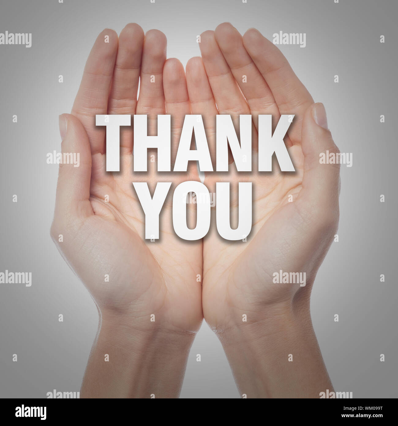 Two hands holding the word thank you Stock Photo - Alamy