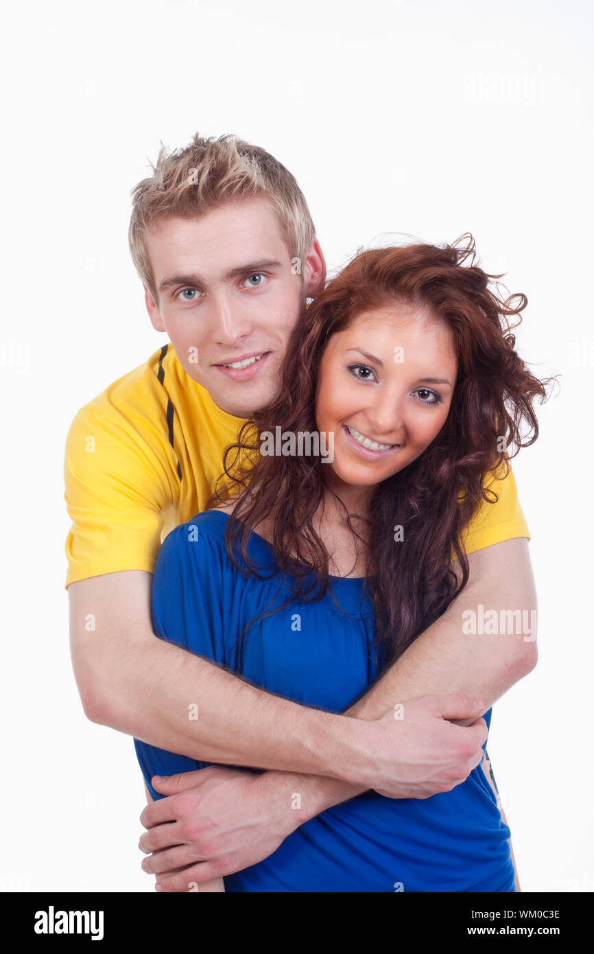 happy young couple - boy embracing girl, smiling - isolated on white ...