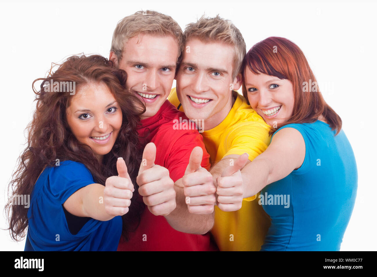 portrait of a group of four happy young people showing thumbs up sign ...