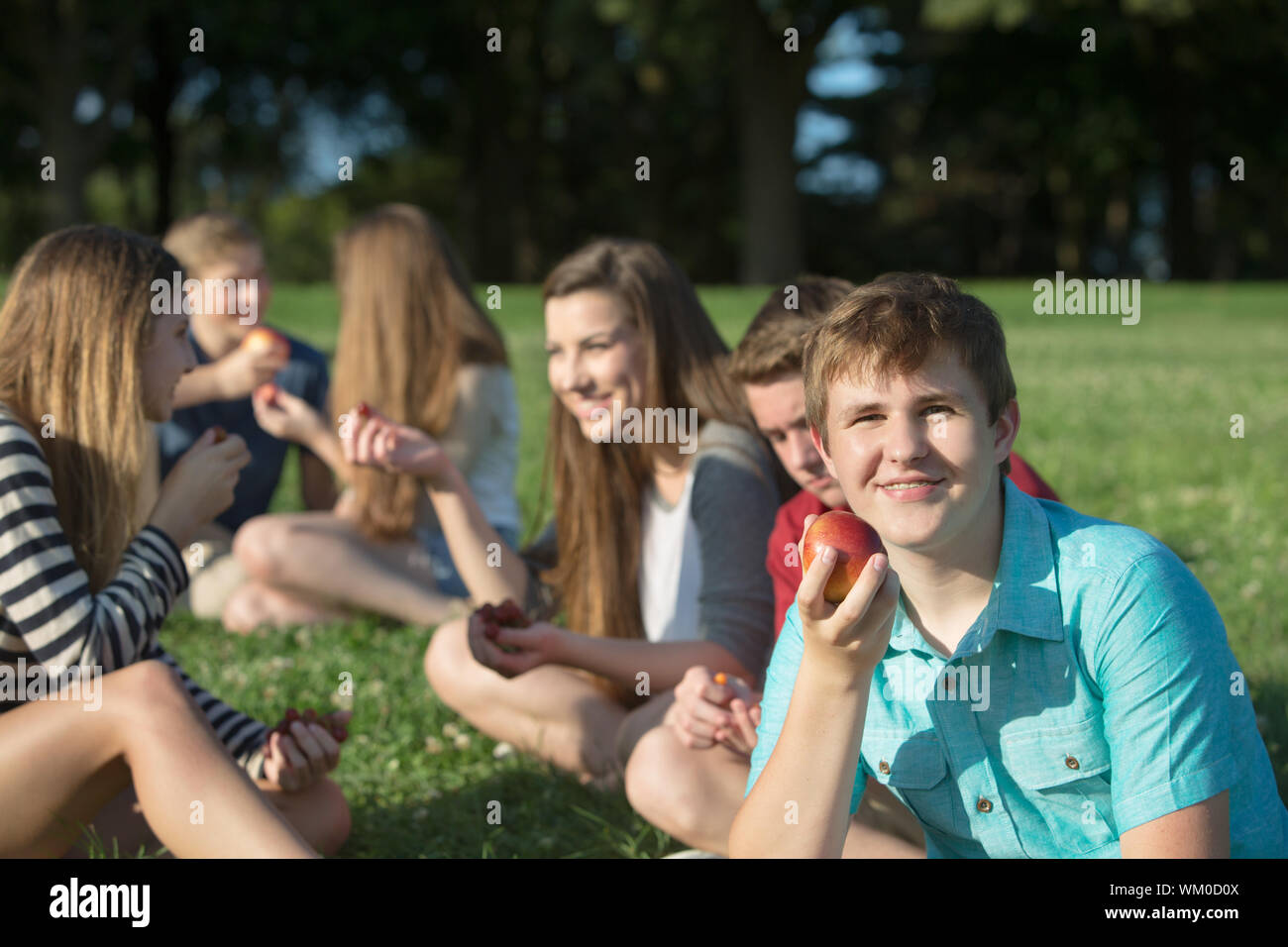 Happy group of teenagers eating healthy snacks outdoors Stock Photo - Alamy