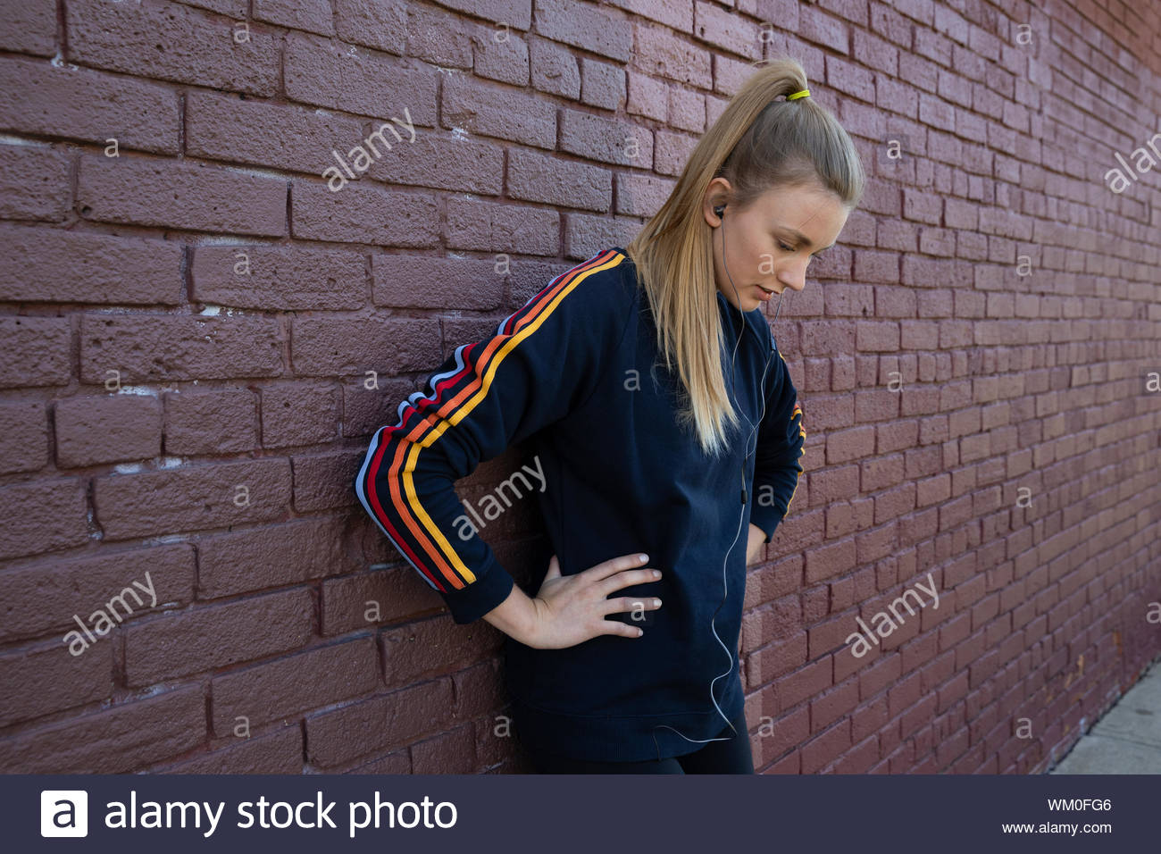 Female against brick wall hi-res stock photography and images - Alamy
