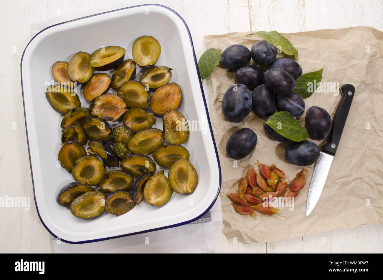 cut plums in an blue and white enamel bowl Stock Photo - Alamy