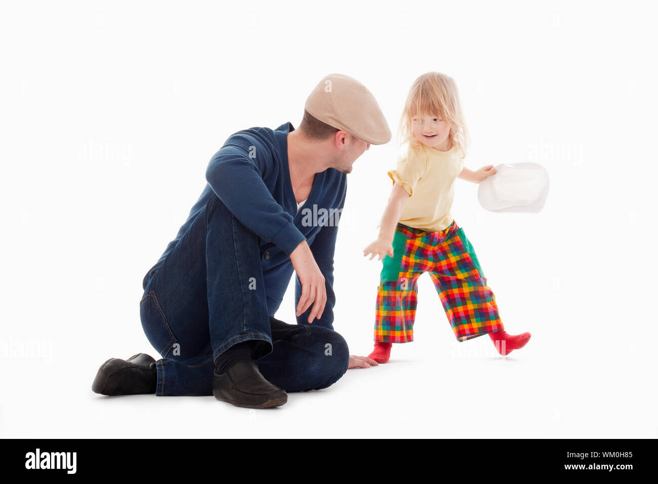 boy with long blond hair having fun with his father - isolated on white ...