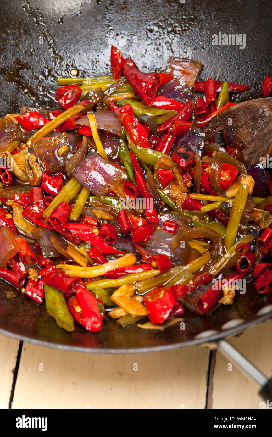 fried chili pepper and vegetable on a iron wok pan Stock Photo - Alamy