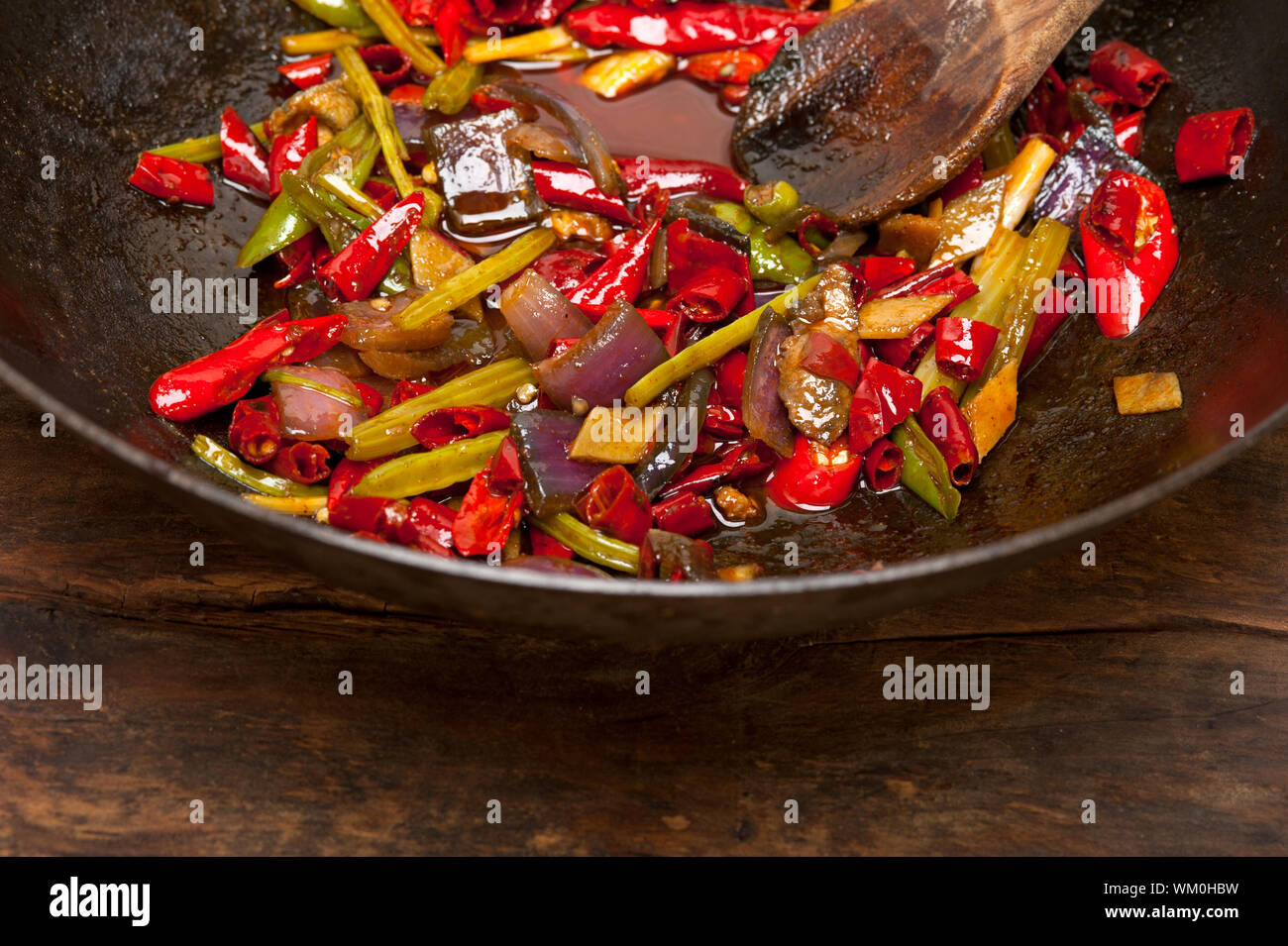 fried chili pepper and vegetable on a wok pan Stock Photo - Alamy