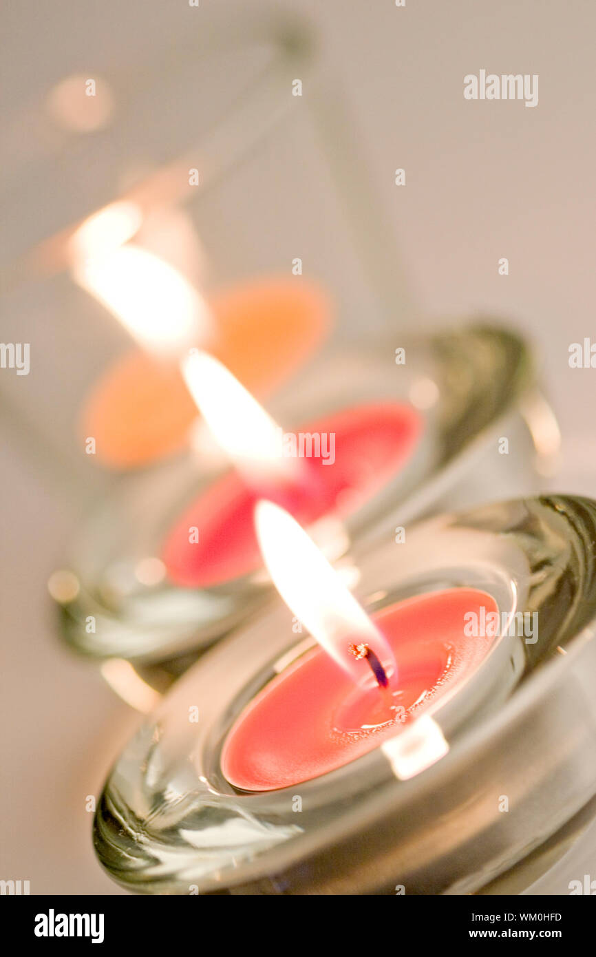 three candles flaming closeup Stock Photo - Alamy