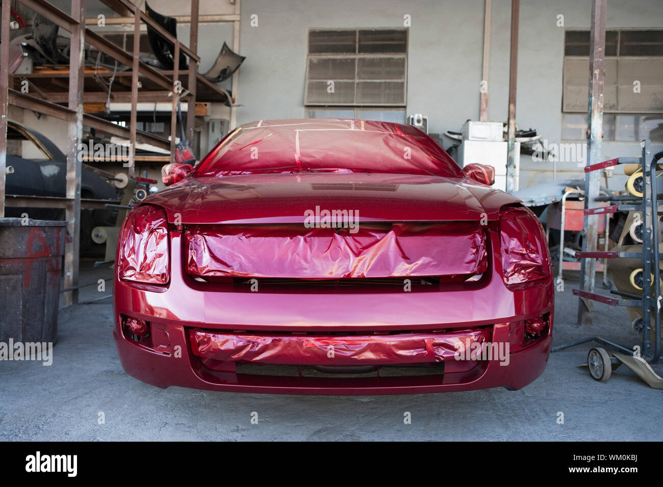 Front shot of a newly red repainted car in garage Stock Photo - Alamy