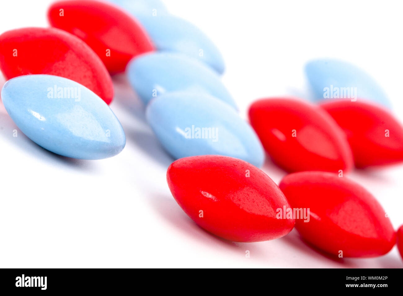 macro image of red and blue pills on white background Stock Photo - Alamy