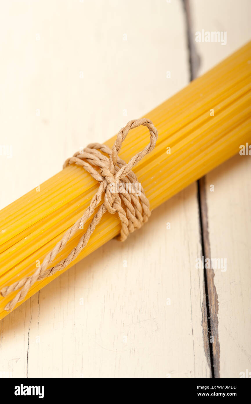 Italian pasta spaghetti tied with a rope on a rustic table Stock Photo ...