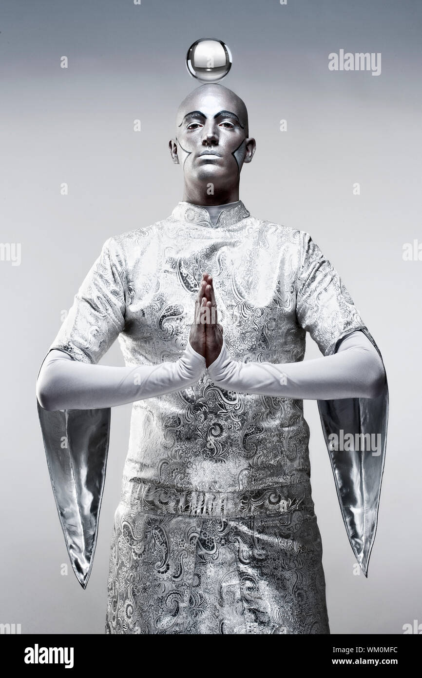 Magician with Glass Balls in Stage Makeup and Costume Stock Photo - Alamy