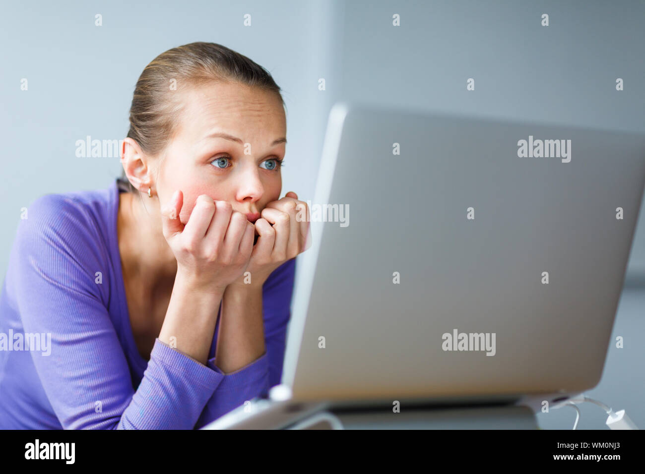 Working too hard - young woman working on a computer at an office ...