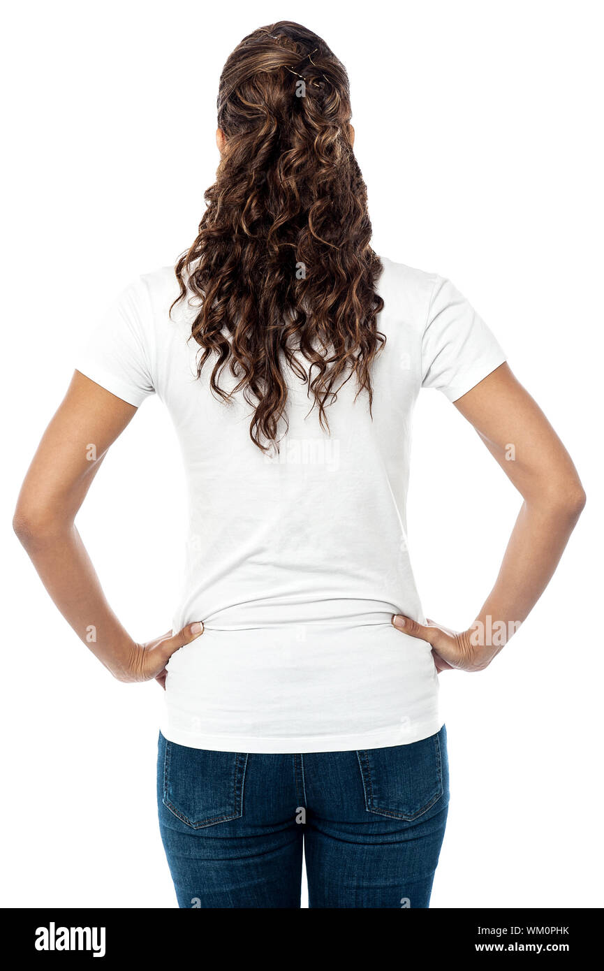 Rear view of young woman with hands on her waist Stock Photo - Alamy