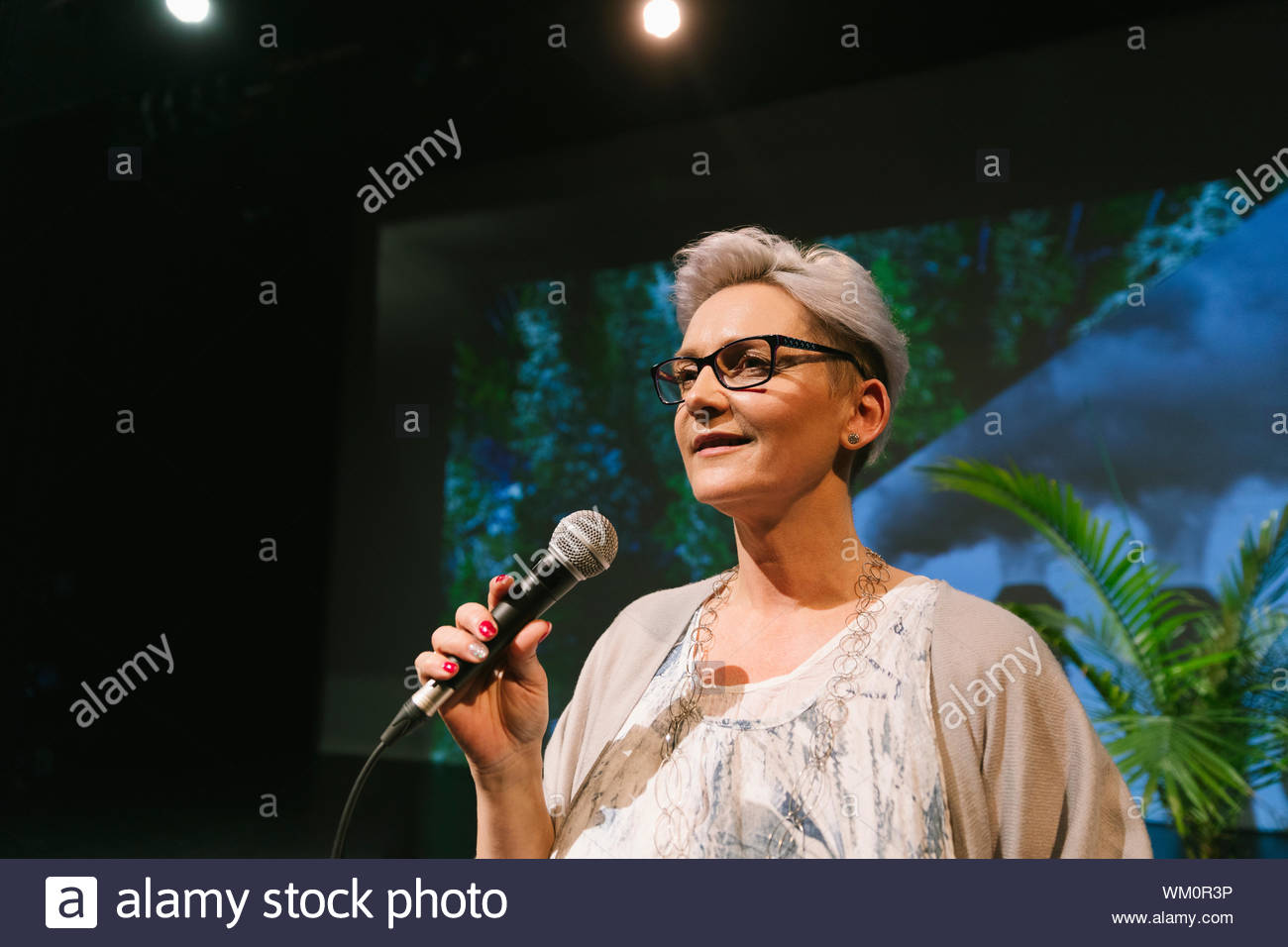 Woman microphone smiling stage hi-res stock photography and images - Alamy