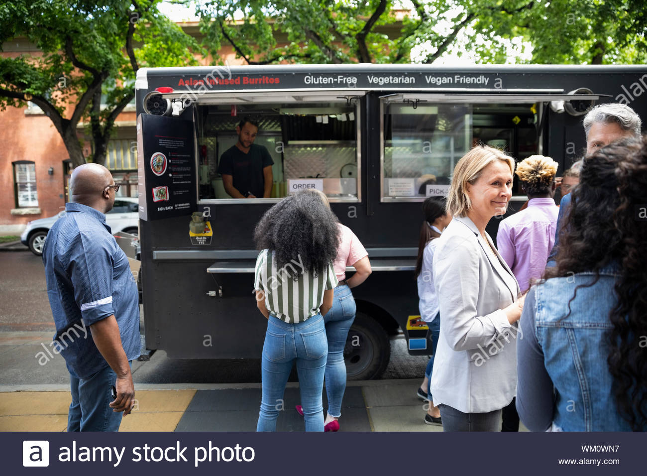 Customers waiting outside food truck Stock Photo - Alamy