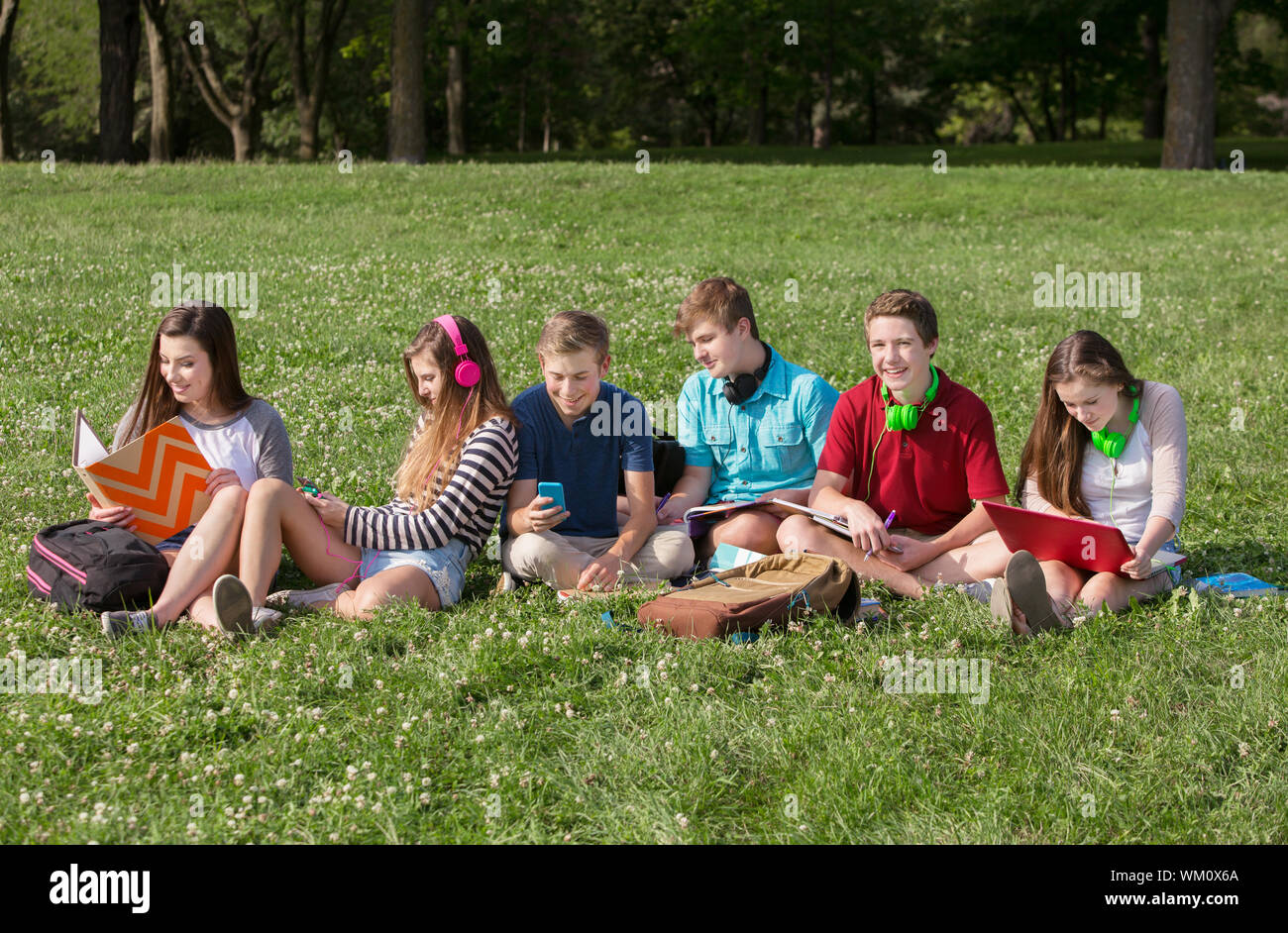 Group of teens using technology for studying Stock Photo - Alamy