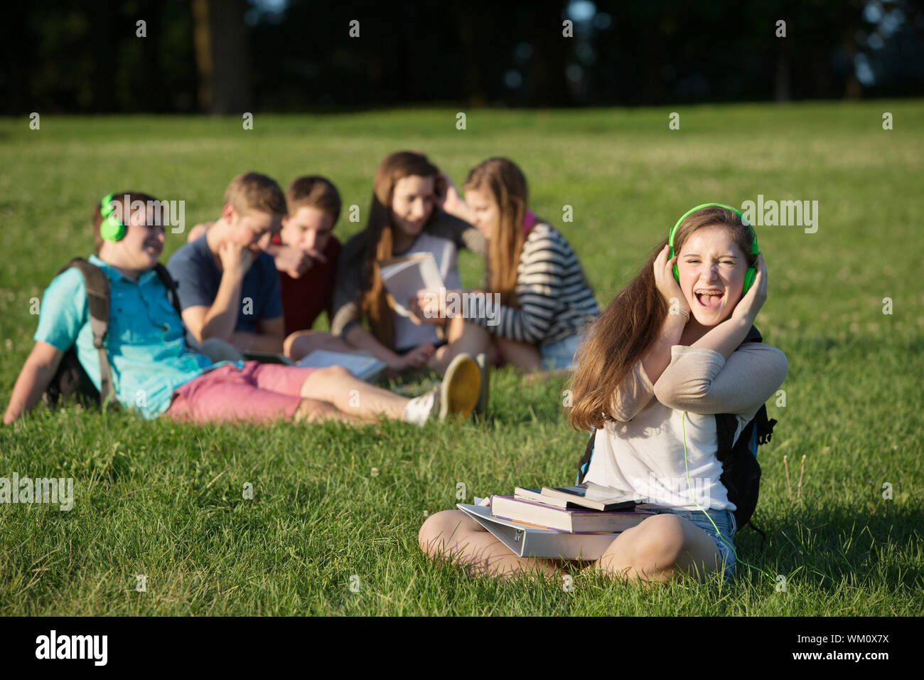 Cute singing female student with group outdoors Stock Photo - Alamy