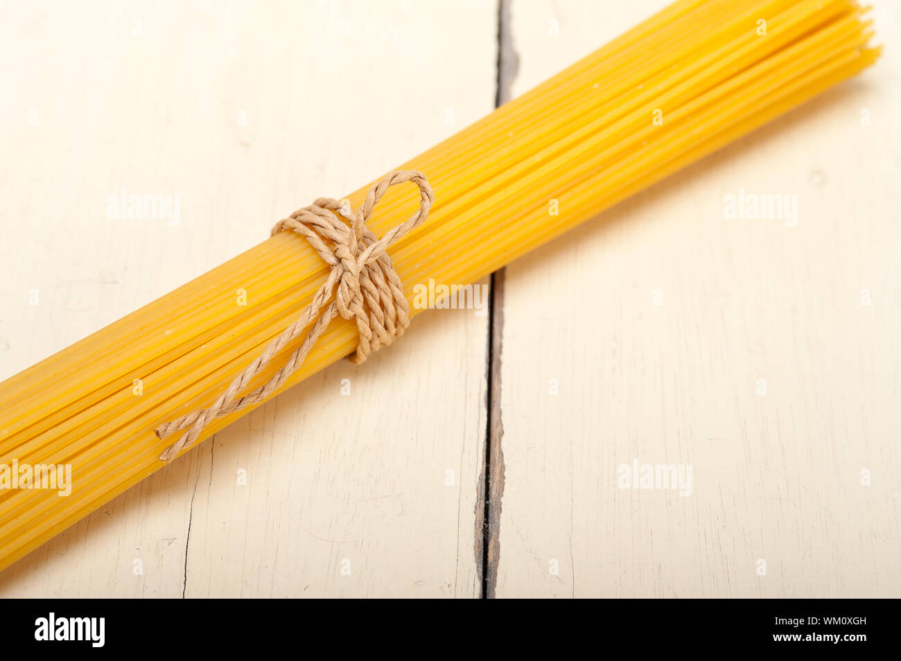 Italian pasta spaghetti tied with a rope on a rustic table Stock Photo ...