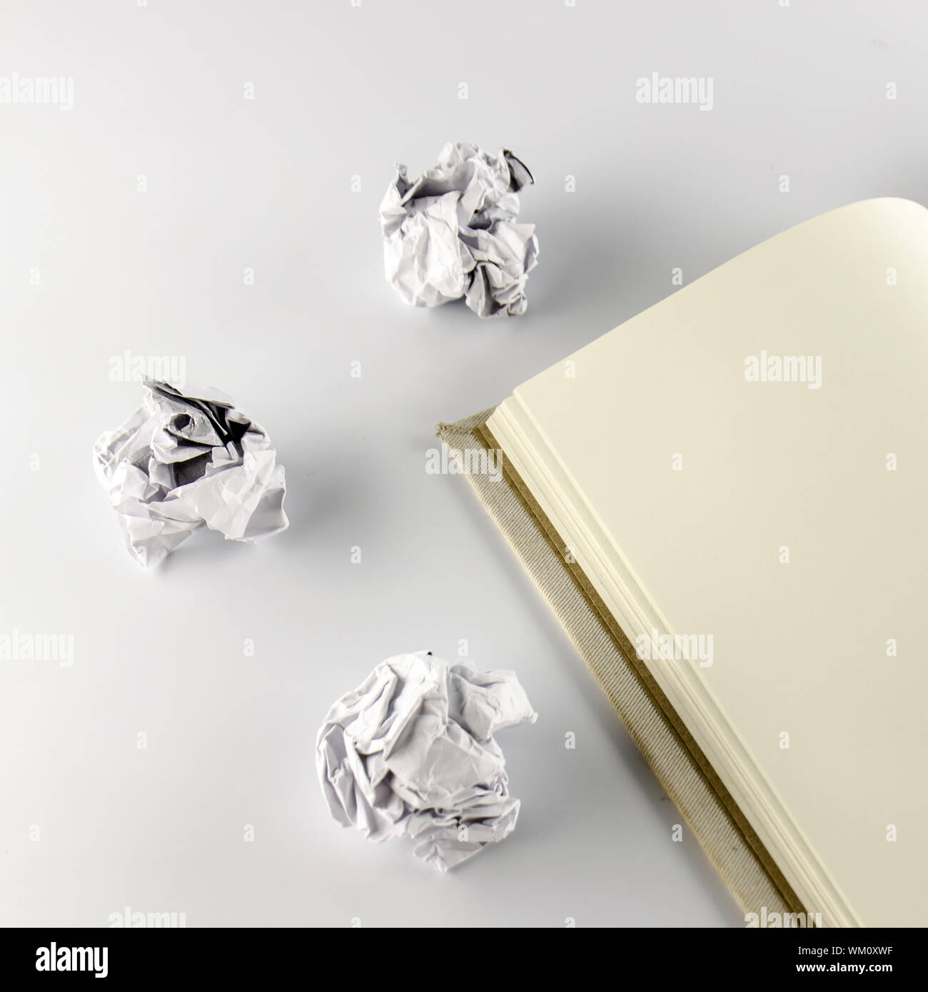 crumpled paper and notebook on a white background Stock Photo - Alamy