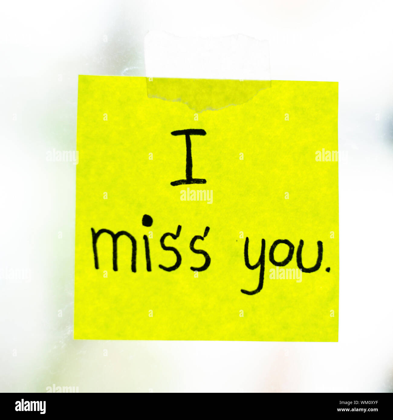 I miss you word sticky note on window mirror Stock Photo - Alamy
