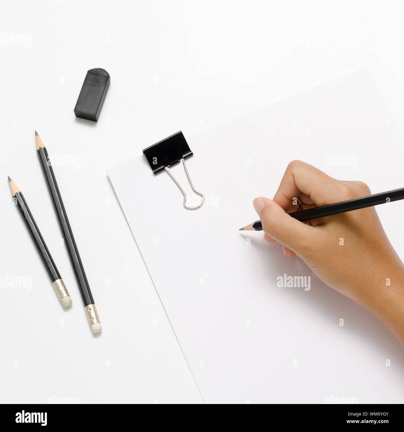 asia woman right hand writing with black pencil on paper over white ...