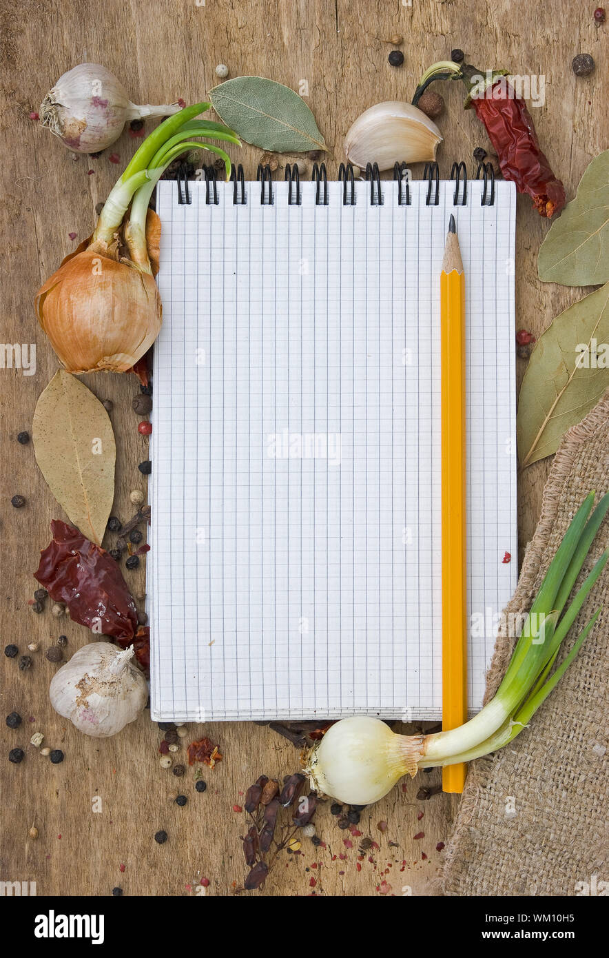 notebook to write recipes on the background of a cutting board with ...