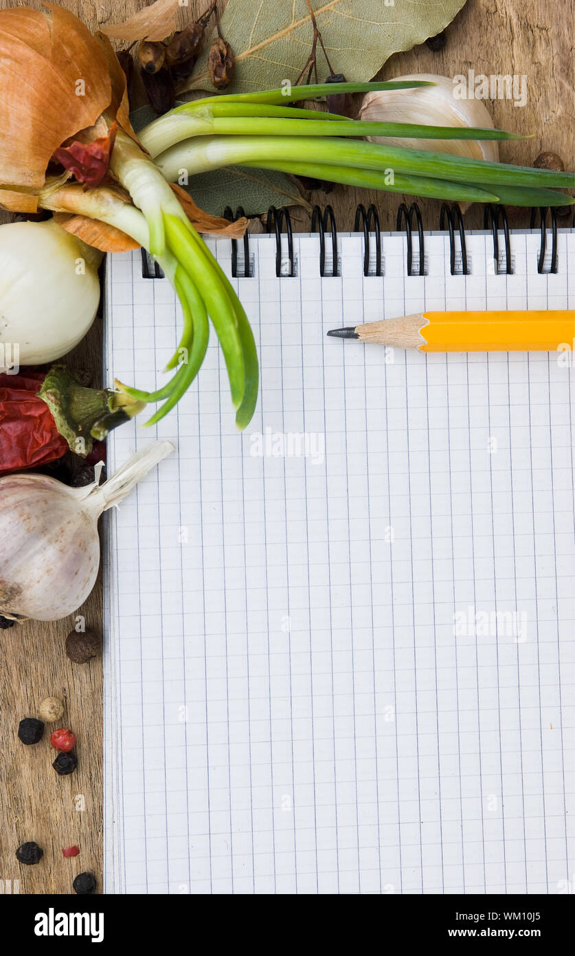 notebook to write recipes on the background of a cutting board with ...