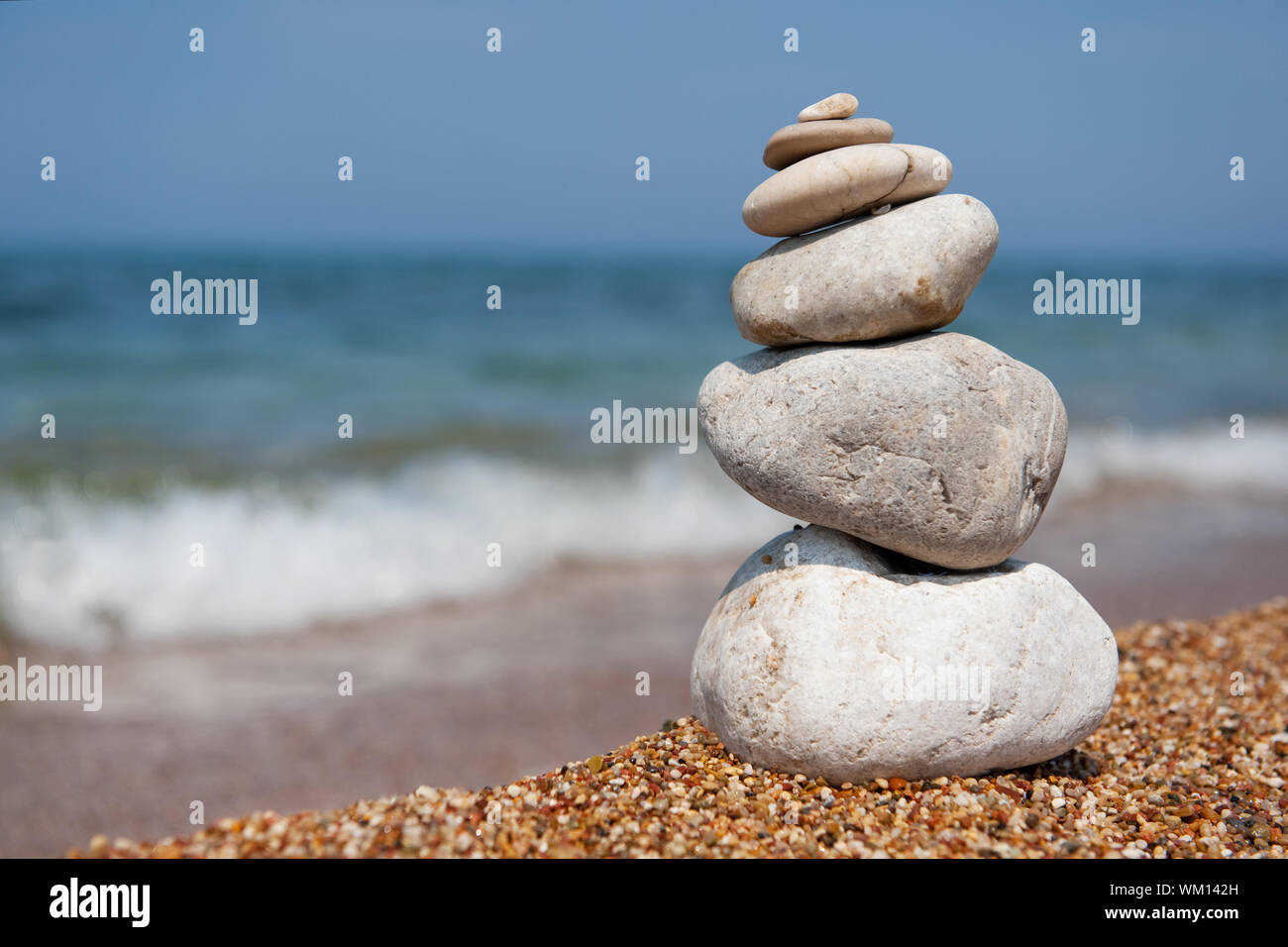 Spa with a pile of pebbles at the beach Stock Photo - Alamy