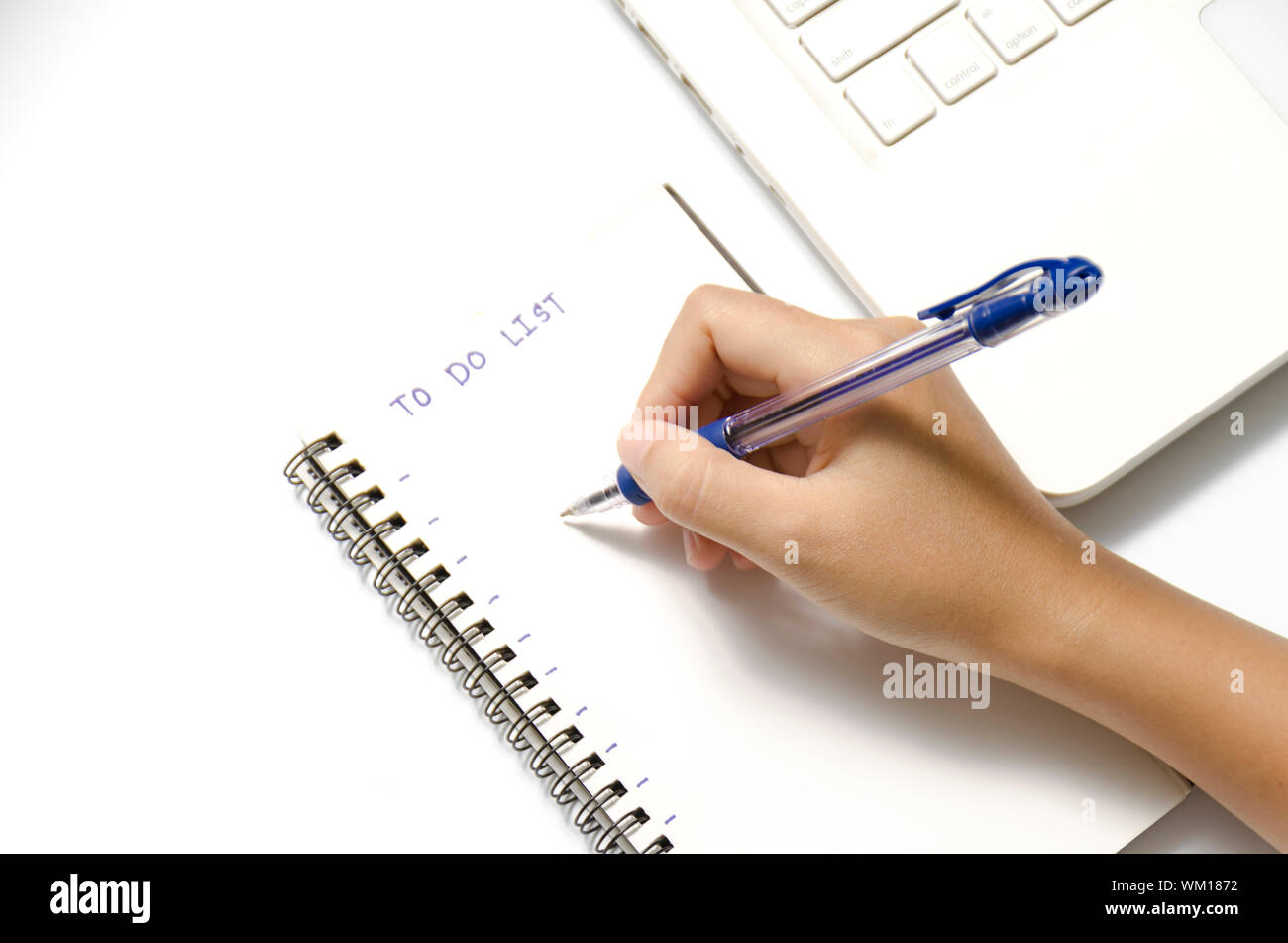 woman hand writing with pen on notebook write to do word and laptop ...