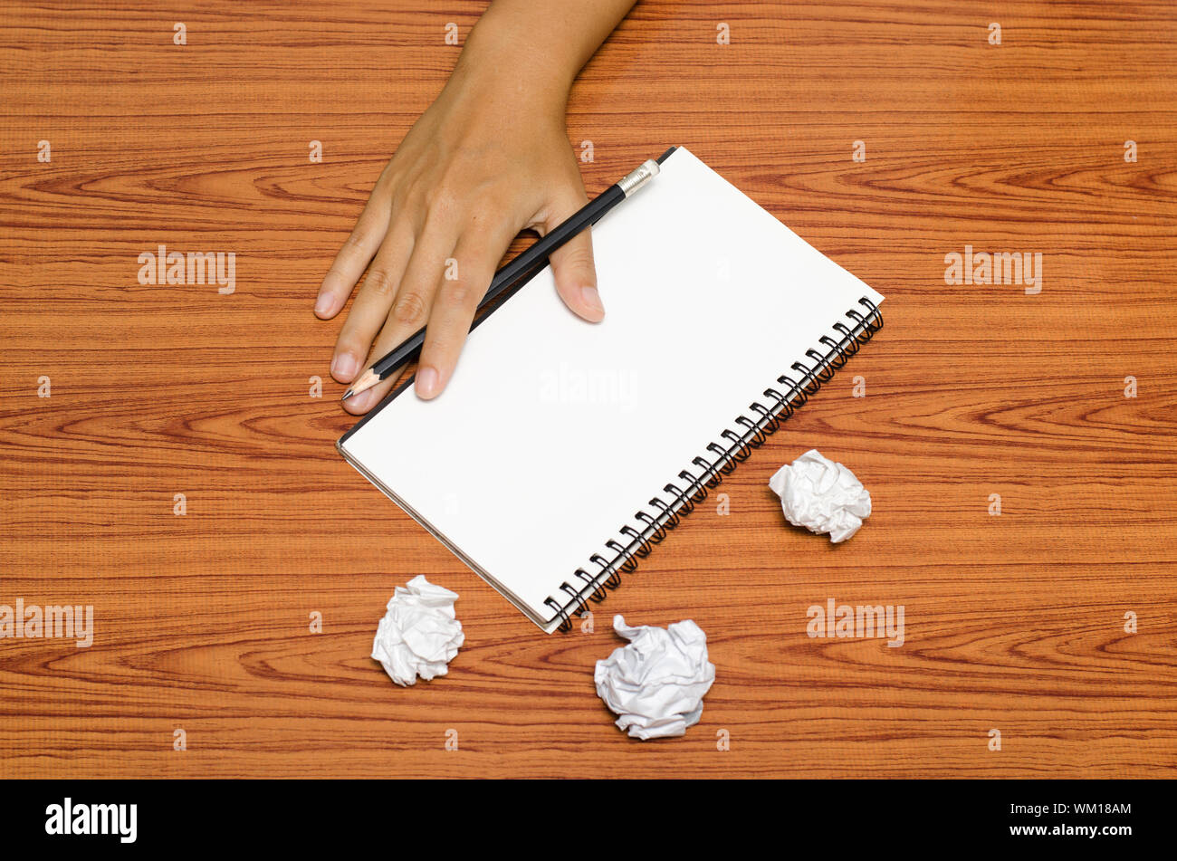 hand writing on notebook with crumpled paper on wood table background ...