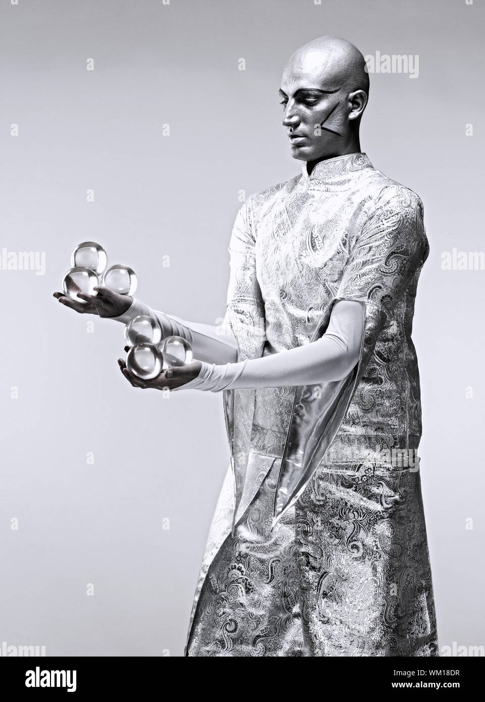 Magician with Glass Balls in Stage Makeup and Costume Stock Photo - Alamy