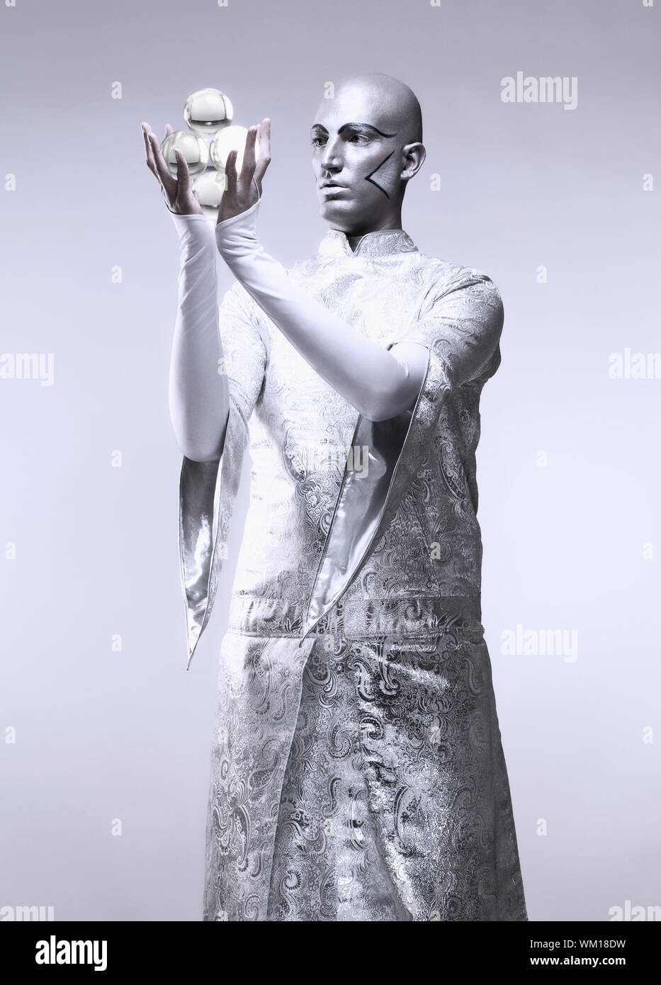 Magician with Glass Balls in Stage Makeup and Costume Stock Photo - Alamy