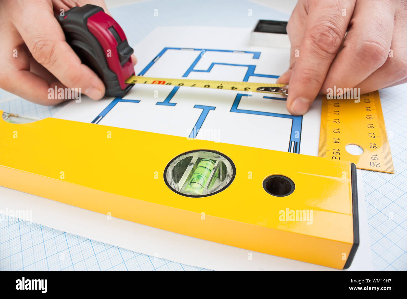 drawing at home with construction tools on a background of graph paper ...