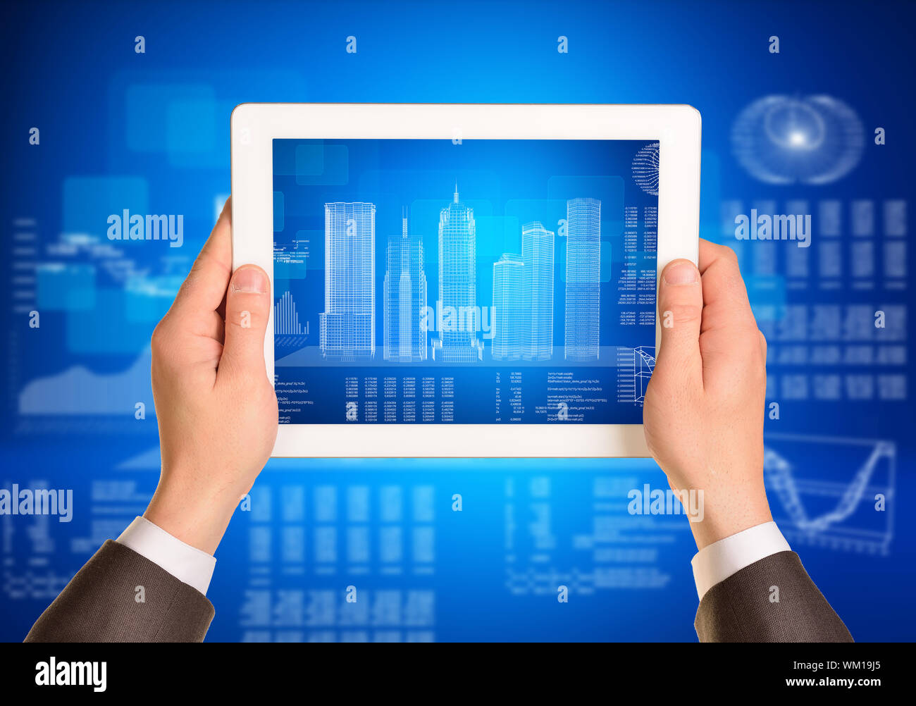 Man hands using tablet pc. Image of wire-frame buildings on tablet ...