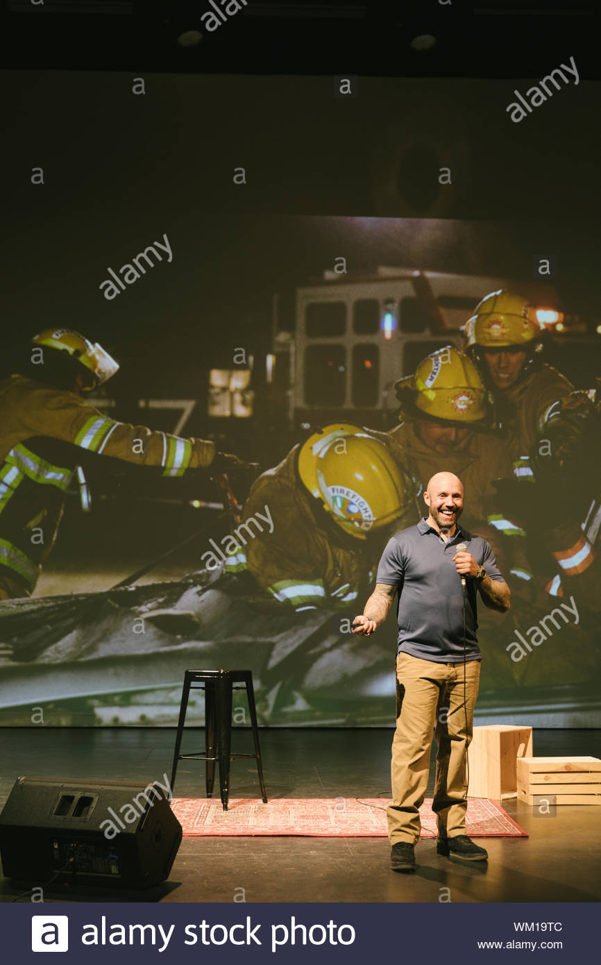 Male firefighter giving inspirational speech on stage Stock Photo - Alamy