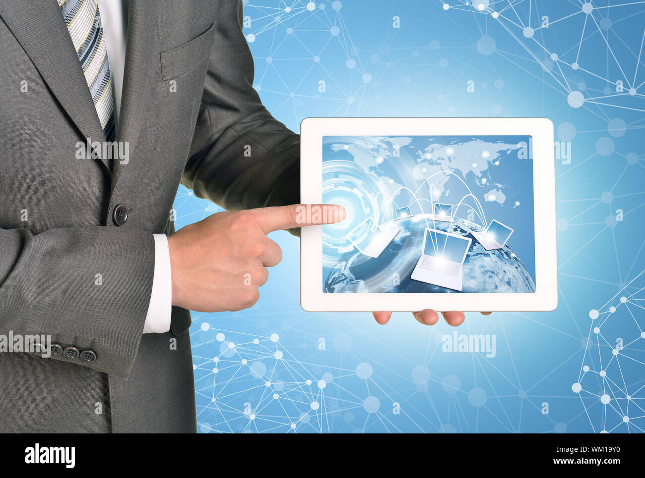 Man hands using tablet pc. Image of Earth and laptops on tablet screen ...