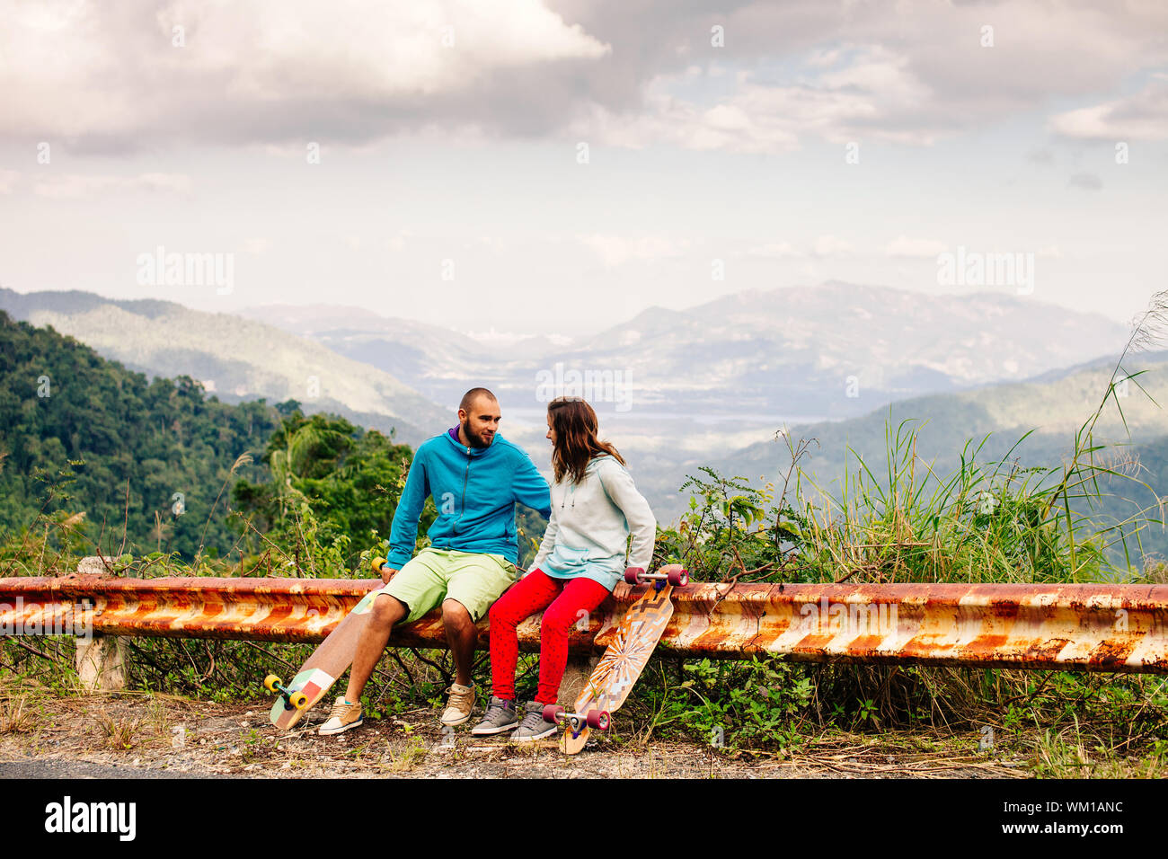 Two couple sitting on fence hi-res stock photography and images - Alamy