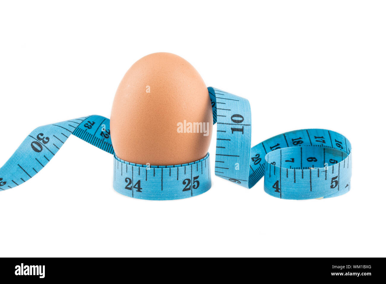 Egg and measuring tape Cut Out Stock Images & Pictures - Alamy