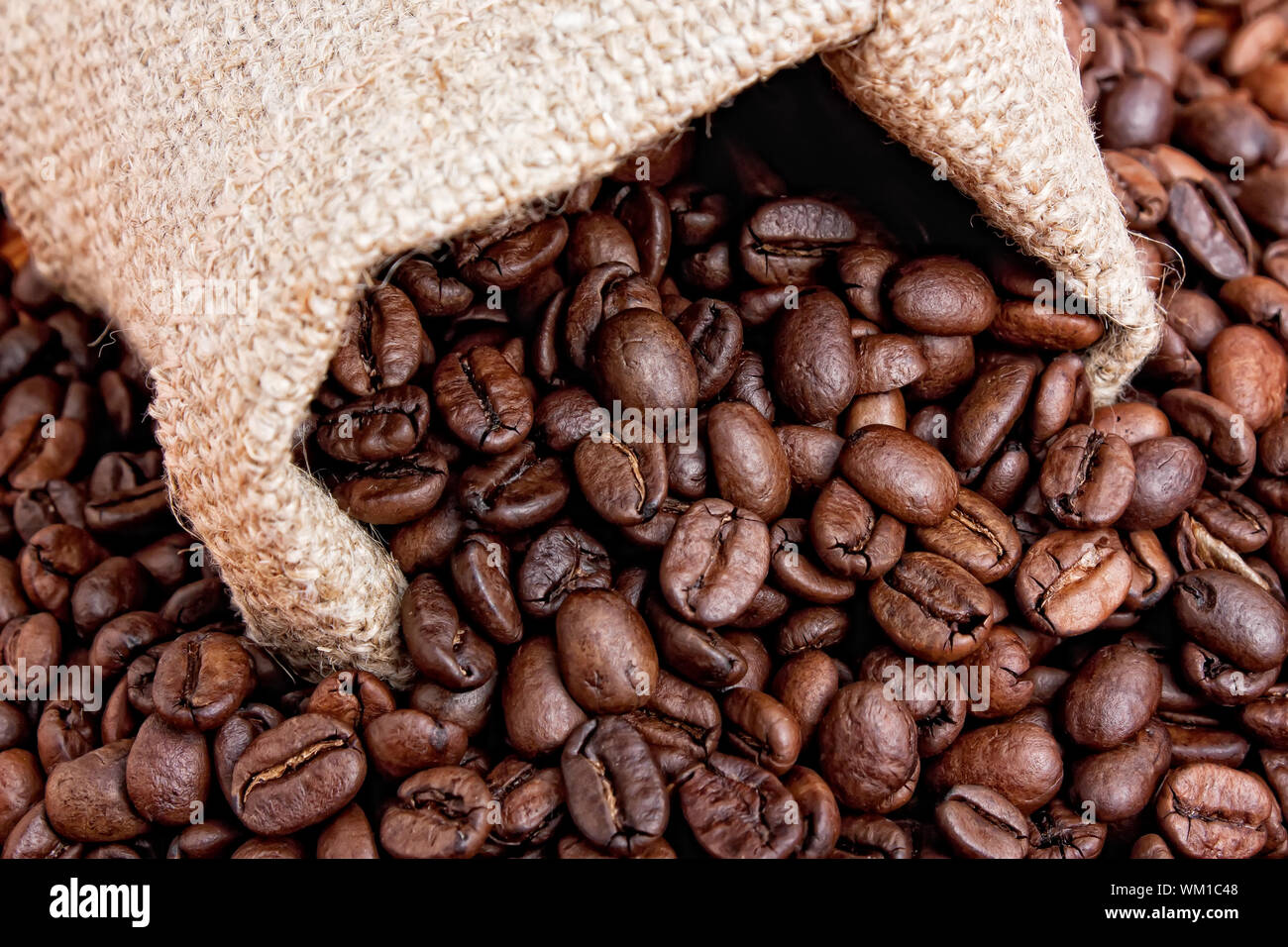 Coffee beans spilled out of the bag Stock Photo - Alamy